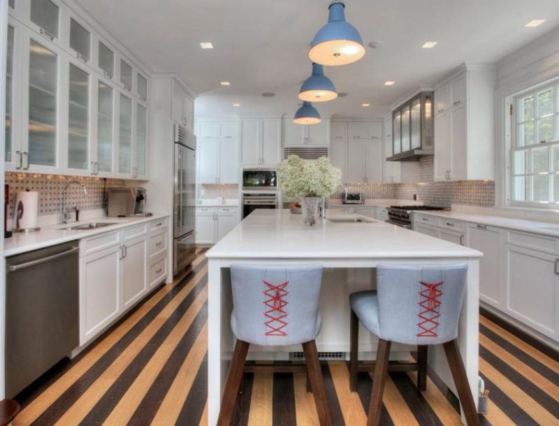 The contrast of white walls and cabinets work in perfect tandem with ...